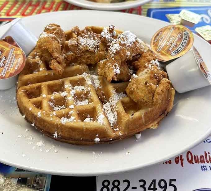 Crispy fried chicken meets a golden waffle, dusted with powdered sugar. This plate is pure Southern poetry.