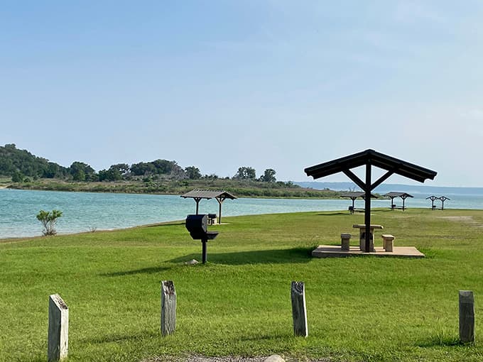Covered picnic shelters, grills, and turquoise water, because every cookout deserves a million-dollar backdrop.