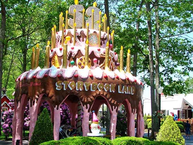 A towering birthday cake sculpture sits proudly in the park, because some celebrations deserve to be permanently immortalized in concrete.
