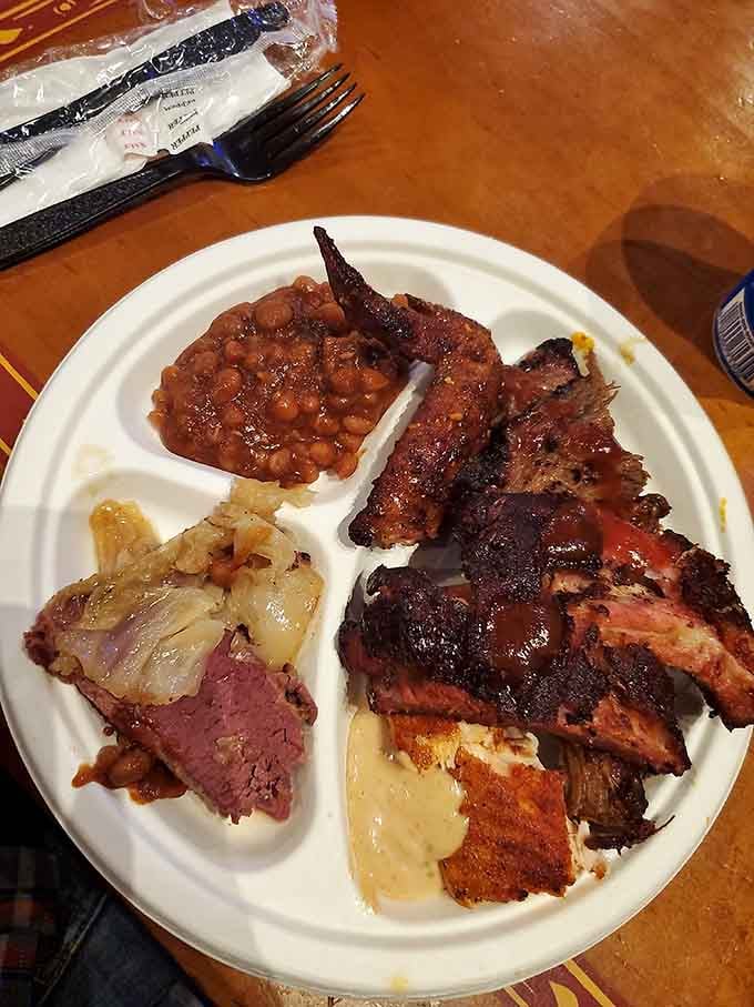 Baked beans, smoked meat, and sides all sharing one plate like old friends who never argue.