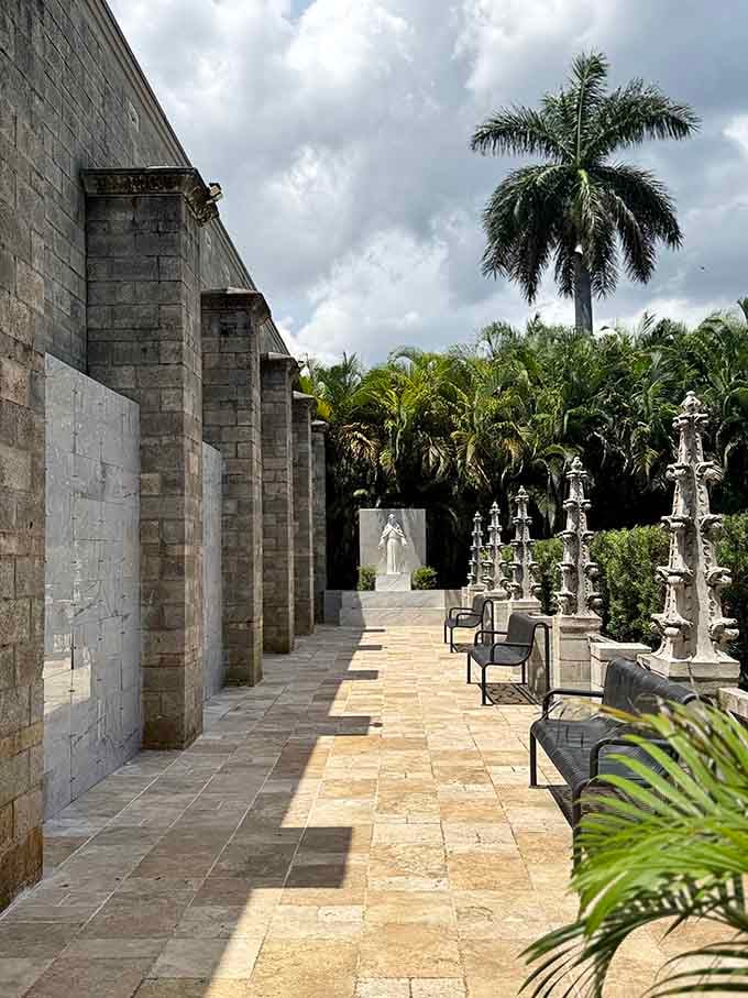 Stone benches, tropical palms, and a serene white statue remind you that peace is always worth seeking.