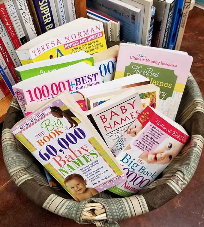 A basket full of baby name books, because apparently 60,000 options still isn't quite enough to decide.