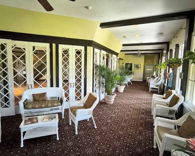 White wicker chairs, tropical plants, and latticed doors, this sunlit corridor makes waiting feel genuinely luxurious.