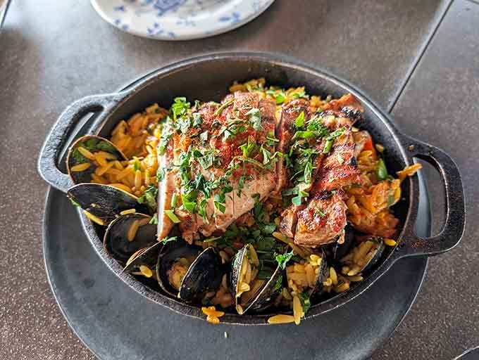 The Foxtail Paella arrives in a cast iron pan like it owns the whole table, because it does.