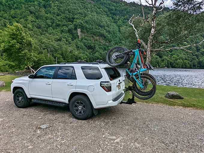 A quiet lakeside pullover with bikes loaded up, because some adventures start before you even hit the trail.