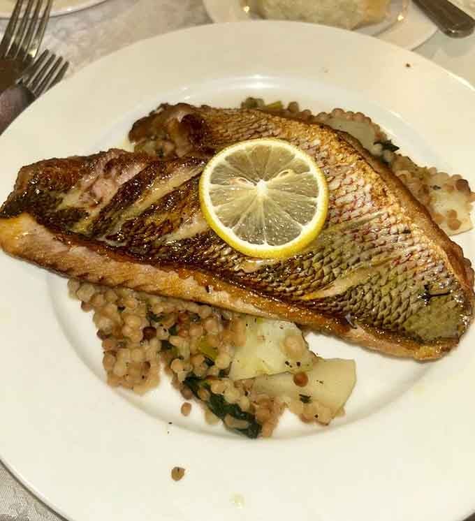 Crispy-skinned red snapper resting on a bed of grains. Simple, confident, and absolutely worth the drive to Jericho.