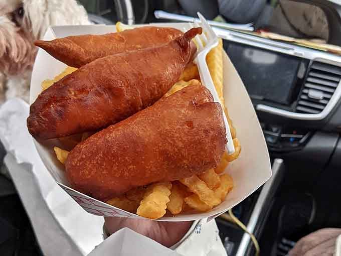 Golden, crispy corn dogs nestled in a bed of crinkle-cut fries. This is what happiness looks like in a cardboard tray.