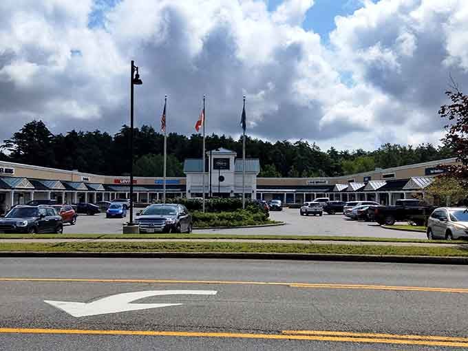 Flags flying high over the main plaza, because patriotism and discount shopping go together like peanut butter and jelly.