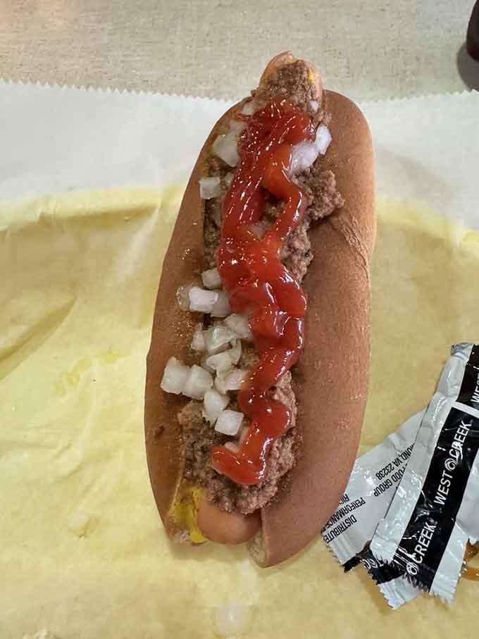 Behold the chili dog all the way, a symphony of flavors that snaps when you bite it.