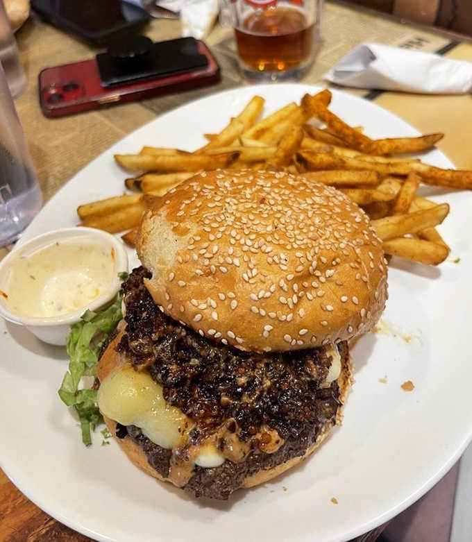 The Bacon Jammin Burger arrives loaded and proud, melted cheese spilling over the edges like it means it.