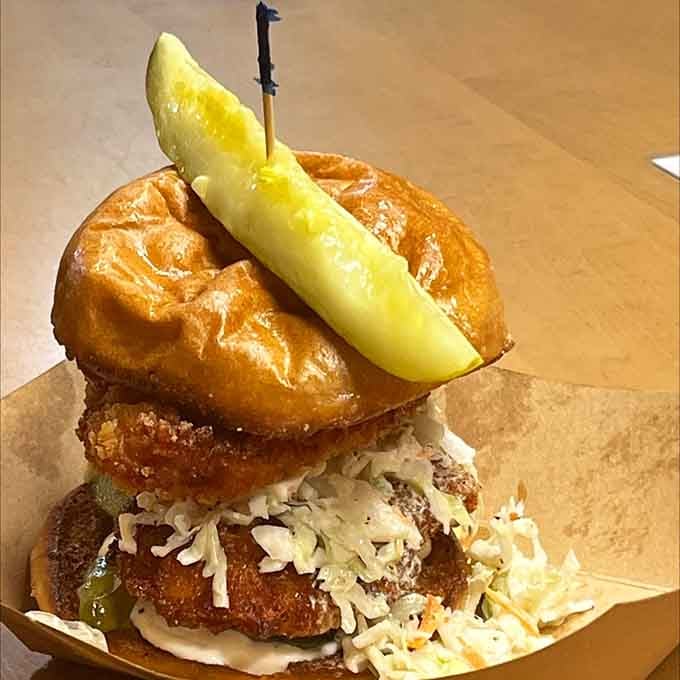 The Nashville Hottie stacked on a pretzel bun with that pickle spear is basically edible architecture at its finest.
