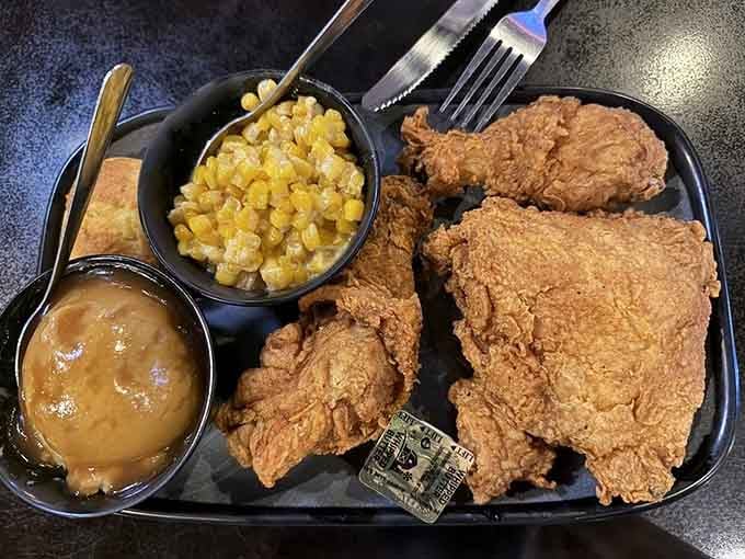 Golden, crispy fried chicken with honey skillet corn and mashed potatoes, this plate is Southern comfort food at its finest.