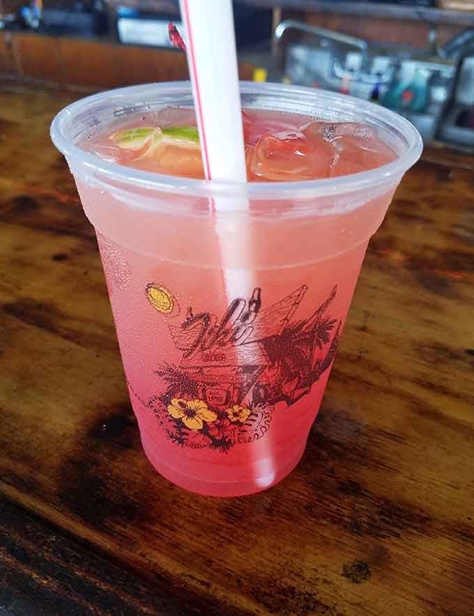 That rosy pink cocktail sitting on the bar is basically sunshine in a plastic cup, sip away.