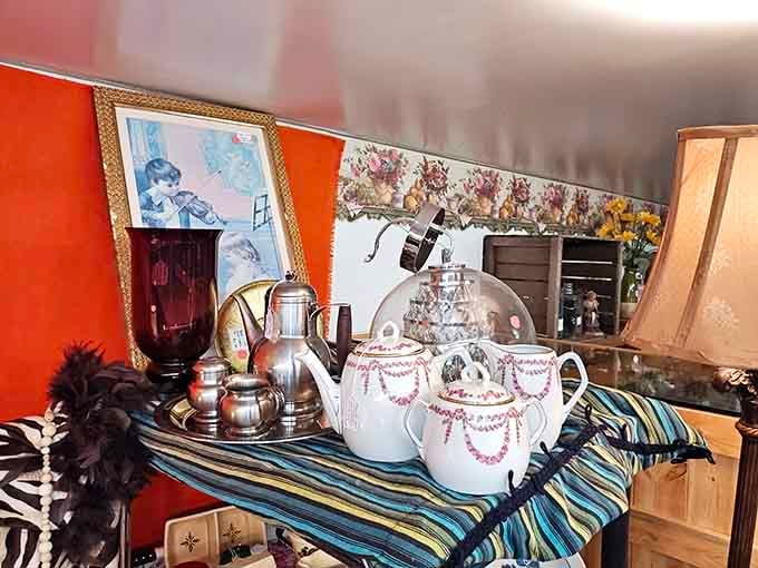 Elegant teapots and silver serving pieces gathered together, as if waiting for a very sophisticated afternoon gathering.