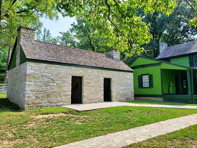 This sturdy limestone outbuilding standing beside the green main house quietly holds stories that textbooks barely scratch the surface of.