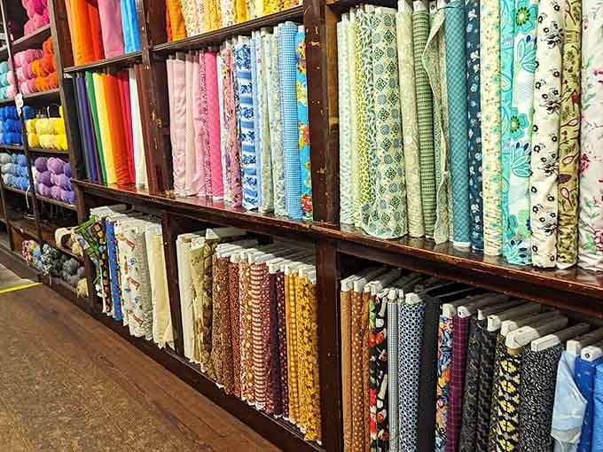 A rainbow of fabric rolls so perfectly organized, it looks like a quilt lover's fever dream come to life.