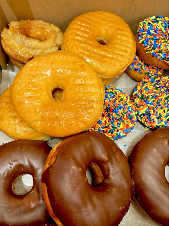 Golden glazed, chocolate-dipped, and rainbow-sprinkled perfection, all nestled together in one happy box.