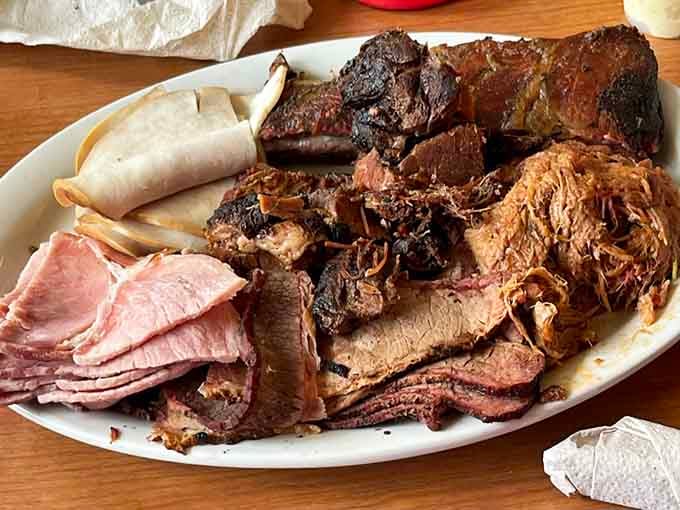 A platter this loaded should come with its own conductor. Brisket, pulled pork, and ham all aboard and ready to go.