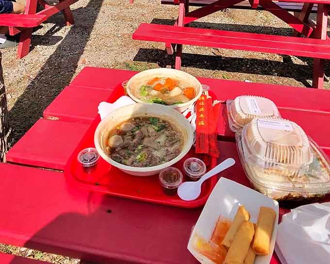 Two bowls of pure comfort sitting on a red tray &mdash; this is Thai soup done absolutely right.