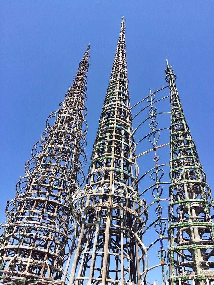 Three soaring spires reaching toward a perfect blue California sky, built without blueprints, cranes, or anyone telling him it couldn't be done.