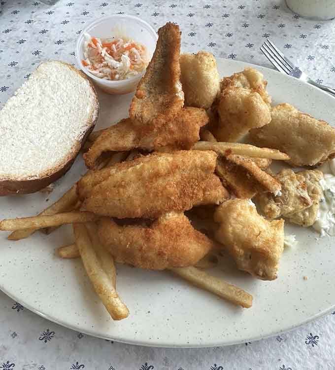 Golden perch and cod nuggets piled high, with fries and slaw completing this glorious Wisconsin plate.