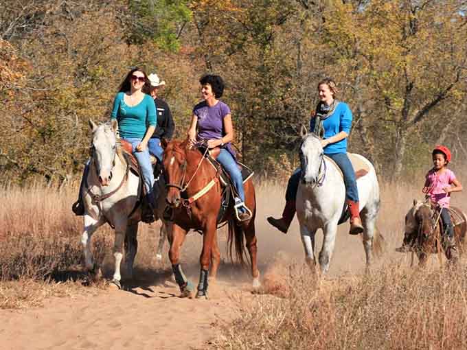 Laughing riders, golden trees, and dusty trails &mdash; horseback riding here looks like pure, unscripted joy.