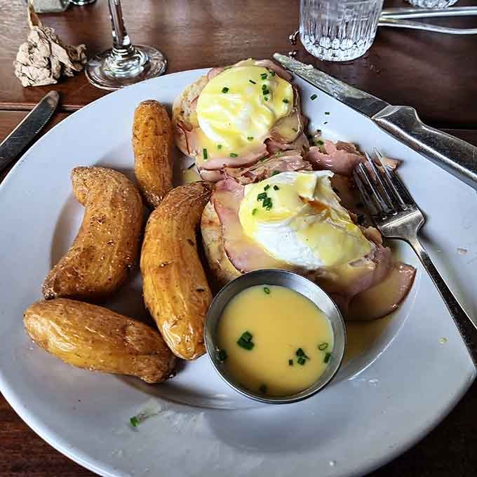 Eggs Benedict so generously stacked, with golden potato wedges alongside, this plate means serious brunch business.