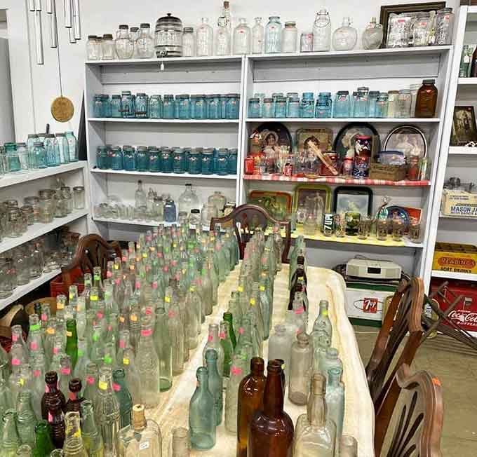 Rows of vintage glass bottles standing at attention, each one a tiny mystery with a cork-shaped past.