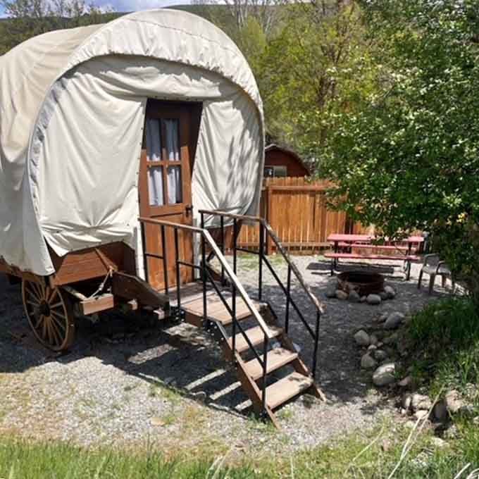 Your covered wagon comes with stairs and a porch, because even time travelers deserve a proper entrance.