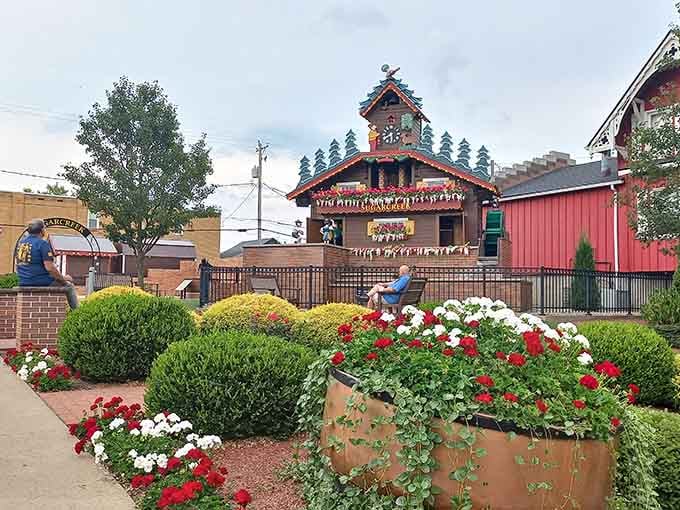 Red and white blooms frame the clock like nature itself dressed up for the occasion.