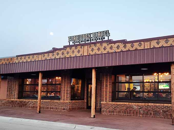 Forbidden Barrel Brewing Company glows warmly at dusk, looking like the kind of place good stories are born over cold craft beer.
