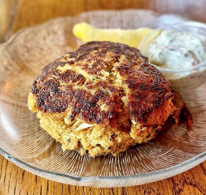 Behold the crab cake that launched a thousand photos and probably caused several structural engineering debates at dinner tables.