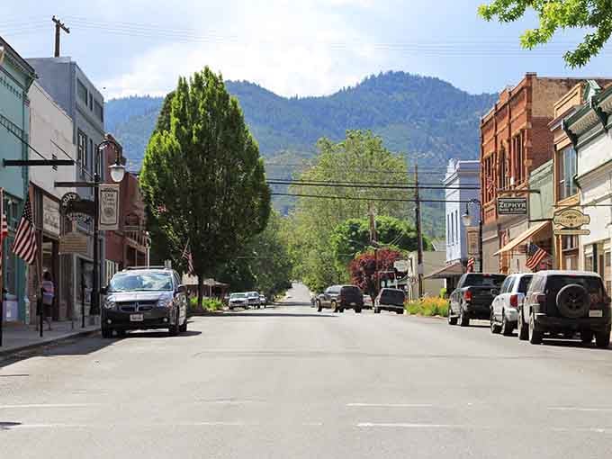 American flags line historic Miner Street, where every storefront tells a story worth slowing down to read.