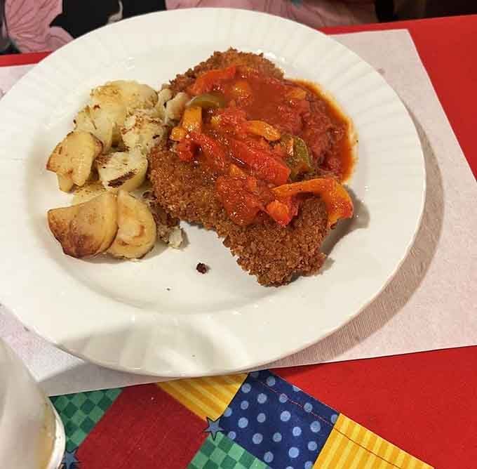 Golden, crispy schnitzel topped with a rich, vibrant sauce and peppers, this plate means serious business in the best possible way.