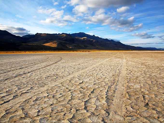 Oregon's high desert playa stretches toward Steens Mountain like nature's own cracked mosaic tile floor, vast and utterly humbling.