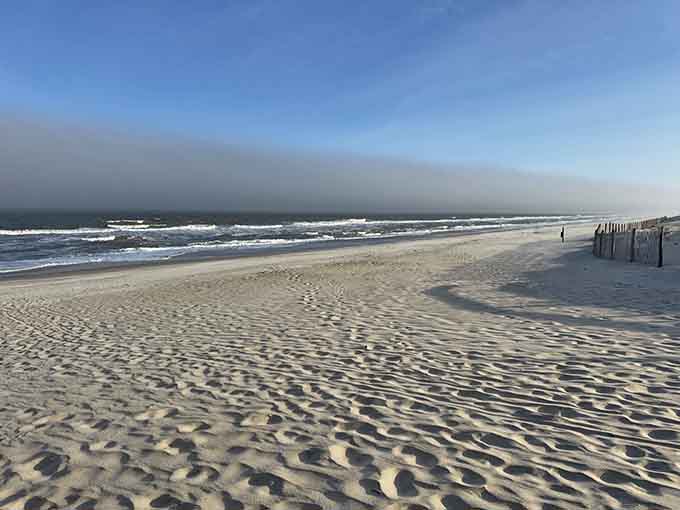 Miles of wide, undeveloped Atlantic beach stretch endlessly under a dramatic cloud bank, offering the kind of solitude you didn't know you needed.