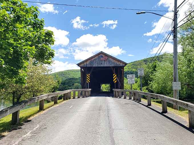 An American flag, rolling green hills, and a wooden tunnel ahead — this is a postcard that actually exists in real life.