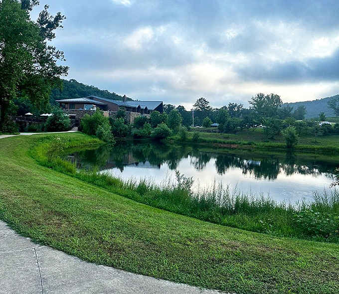 Echo Bluff's lodge reflects perfectly in the still pond below, tucked between Ozark hills like a well-kept secret.