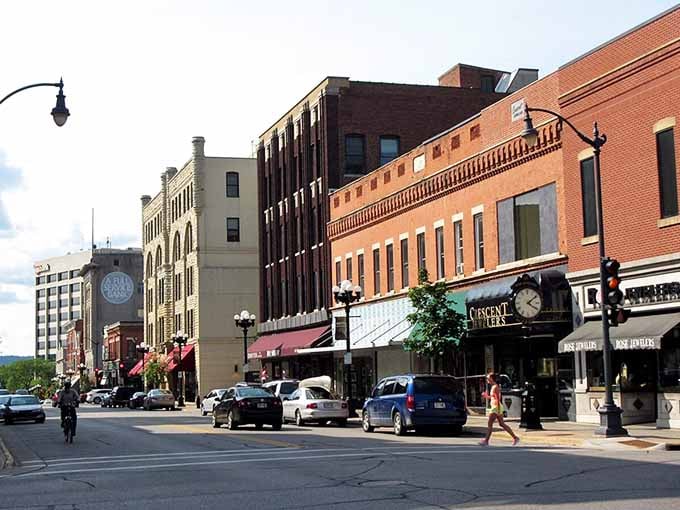 La Crosse's main street charms with classic brick buildings, a vintage street clock, and locally owned shops worth exploring!