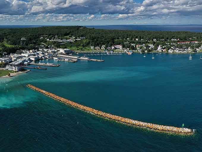 Mackinac Island from the air reveals something remarkable: a jewel-blue harbor cradling one of Michigan's most treasured destinations.