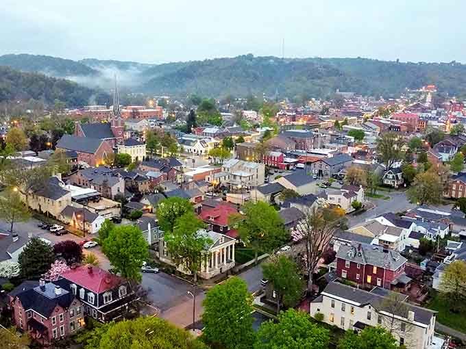 Rolling hills cradle this artistic haven where church spires pierce the sky and every rooftop tells its own colorful story.
