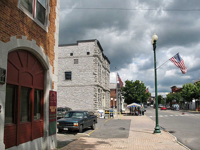 Massena's downtown wears its American flags proudly, with stone and brick buildings that look built to outlast everything.