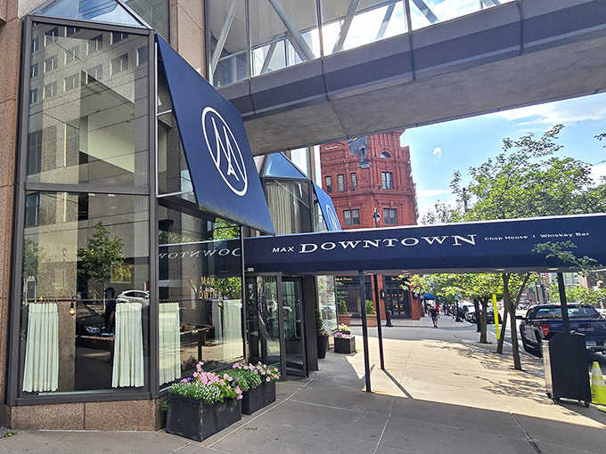 Navy awnings, fresh flower boxes, and Hartford's skyline backdrop make Max Downtown look effortlessly cool on a summer afternoon.