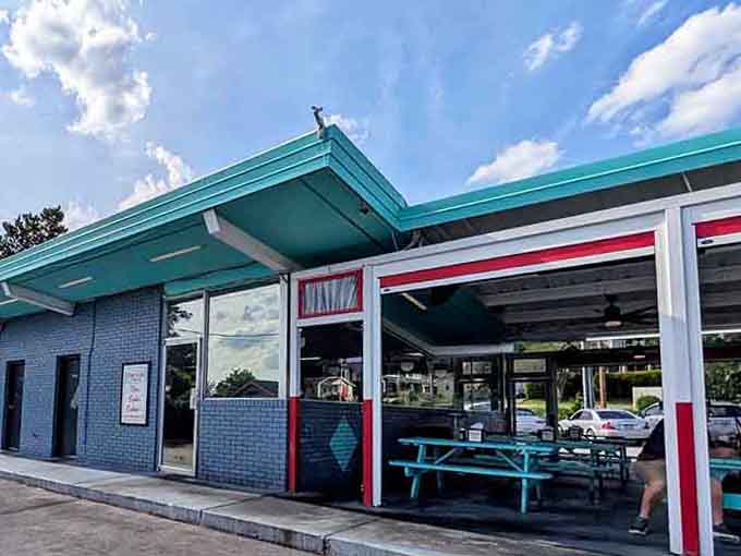 That bold teal roofline against a summer sky is basically a retro postcard begging to be lived in person.