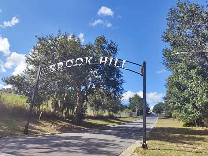 That cheerful "Spook Hill" archway is basically Florida's version of a haunted house entrance, minus the fog machine and jump scares.