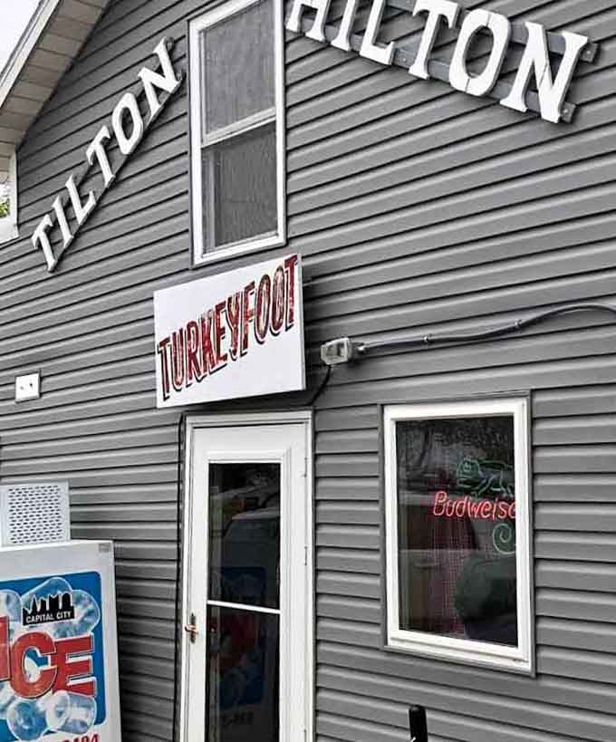 Two signs, one building, zero pretense: the Tilton Hilton's "Turkeyfoot" marquee is the most delightfully puzzling welcome in Lakeview.