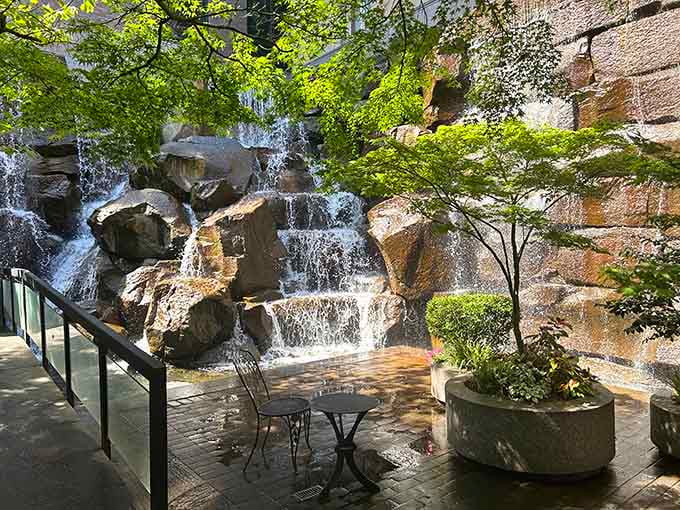 Tucked between city buildings, this cascading waterfall and its cheerful iron caf&eacute; table make Pioneer Square feel like a secret garden worth finding.