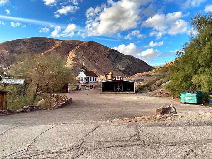 A little schoolhouse and a barn sit quietly at the foot of those sun-baked Mojave hills.