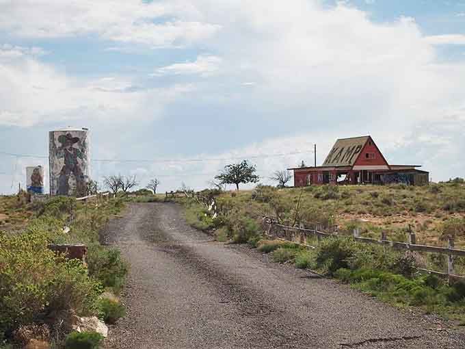 A faded red barn, painted silos, and a gravel road leading nowhere special, yet somehow you can't stop staring at it.