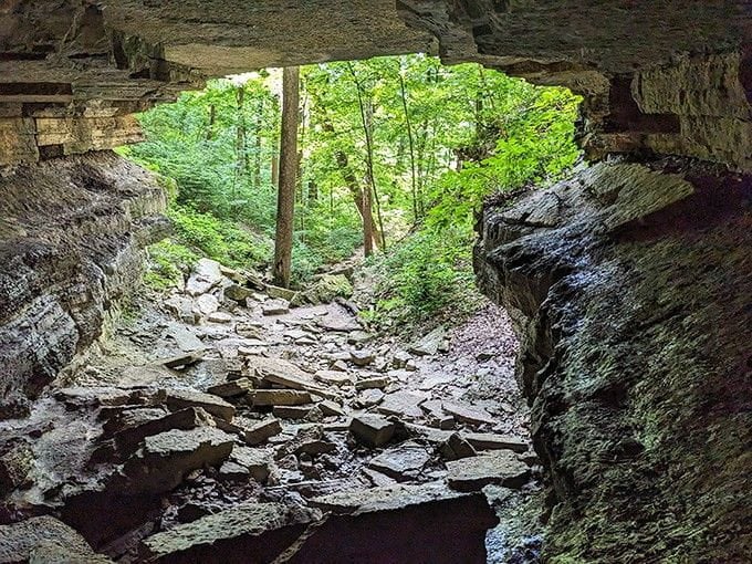 Stepping through this rocky cave opening feels like nature designed its own dramatic doorway just for you.